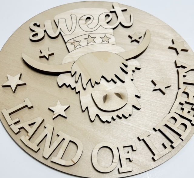 Sweet Land of Liberty Cow Round Doorhanger – Sawdust & Swirls